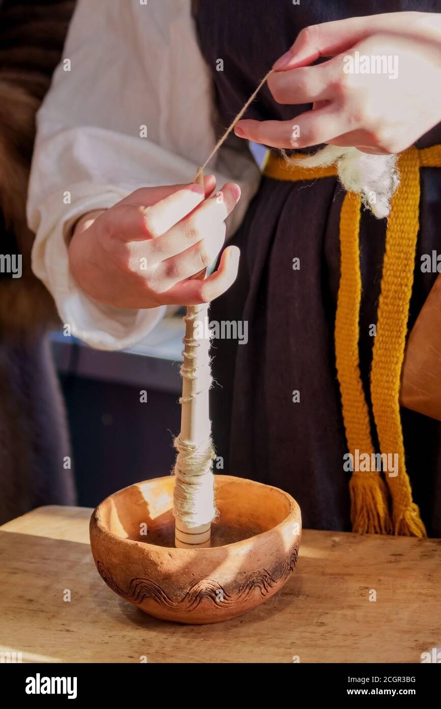 woman in traditional russian clothes weaves a spindle Stock Photo - Alamy