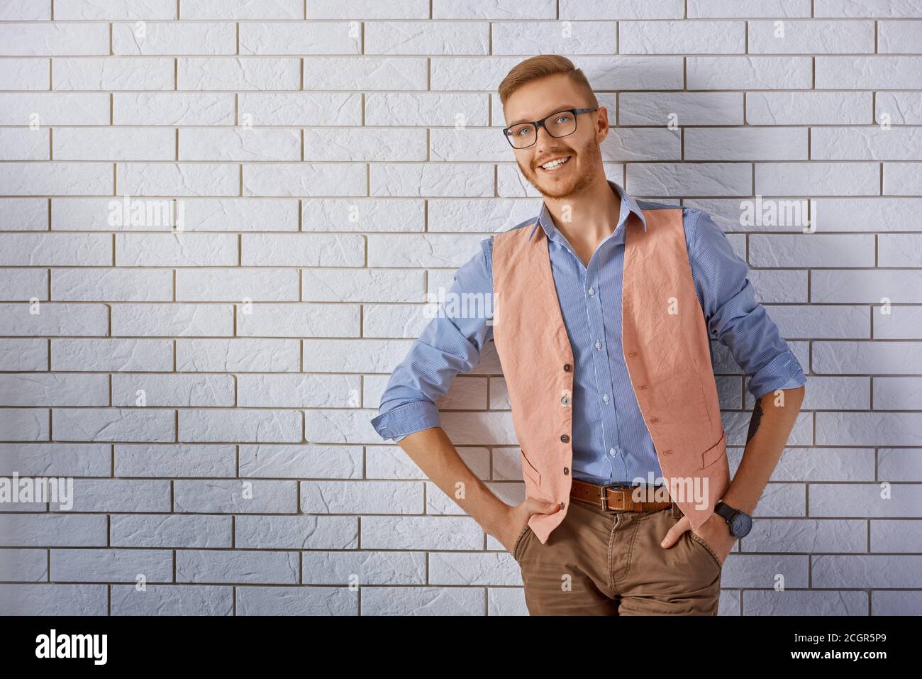 handsome man on the wall background Stock Photo - Alamy