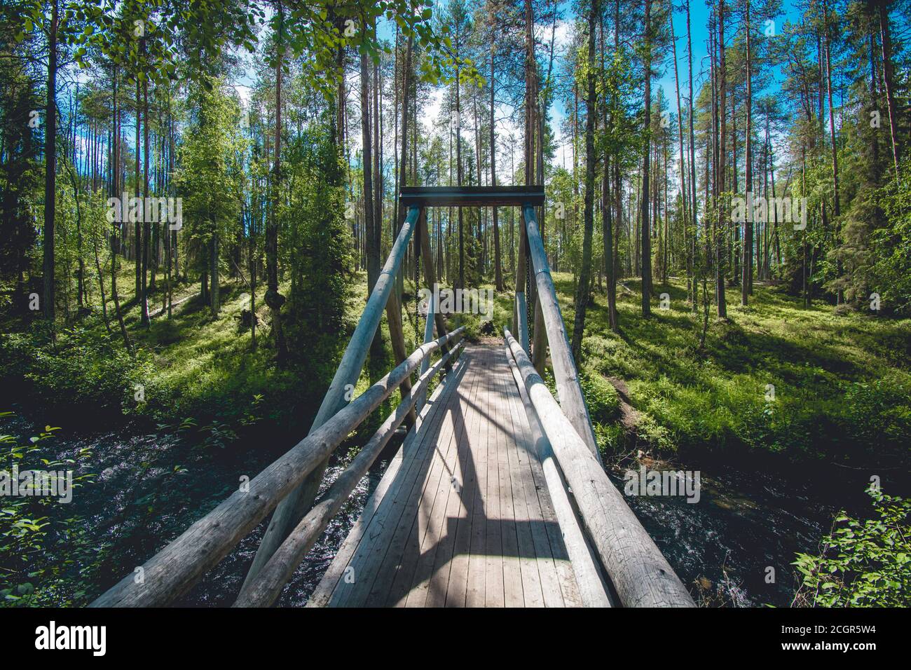 wooden bridge across river in Oulanka national park Finland during ...