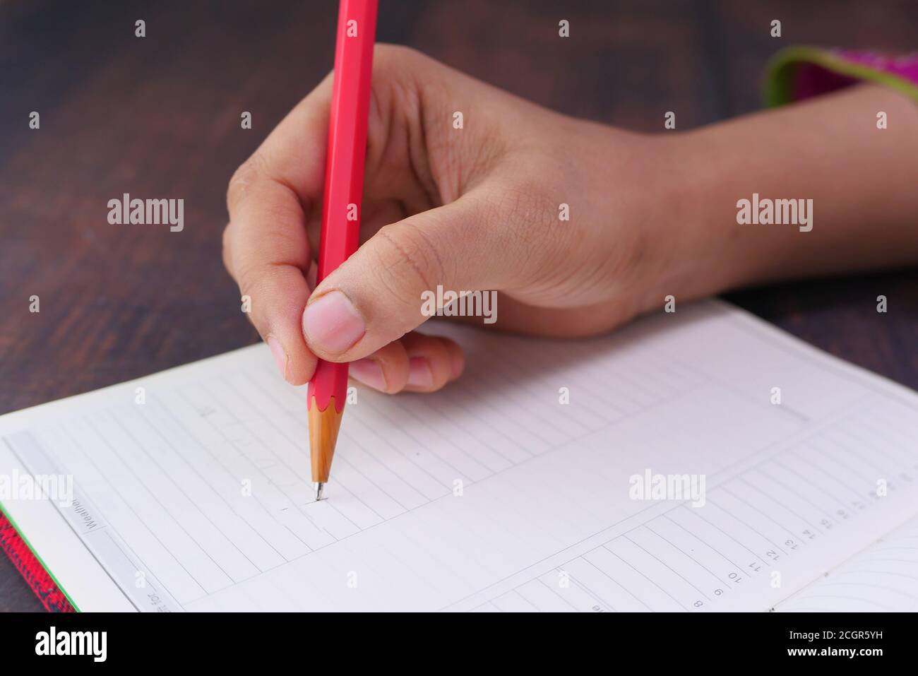 Close up of women hand writing on notepad Stock Photo - Alamy