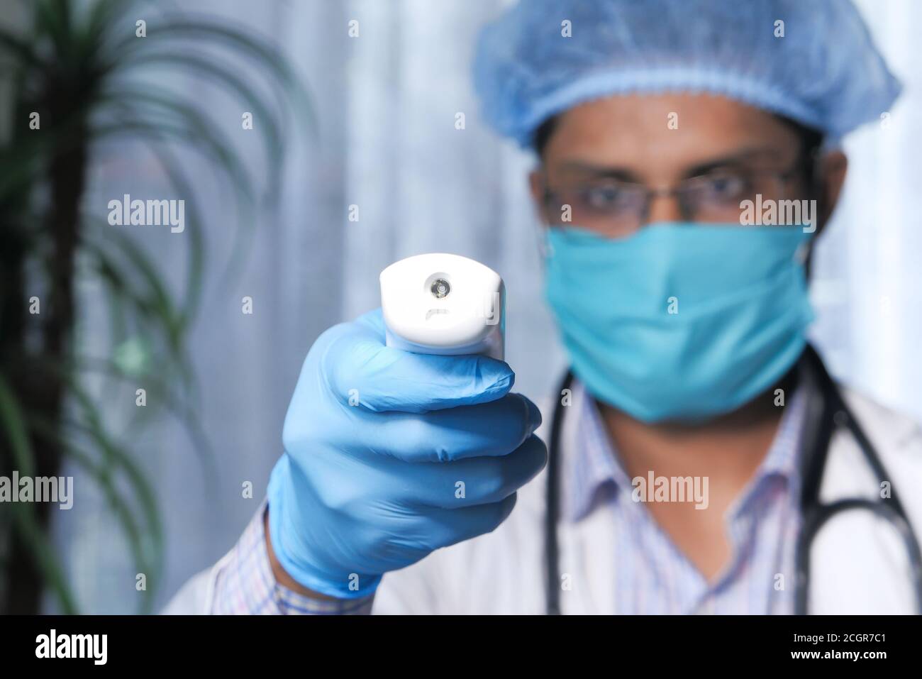 Hand holding infrared thermometer to measuring temperature Stock Photo ...