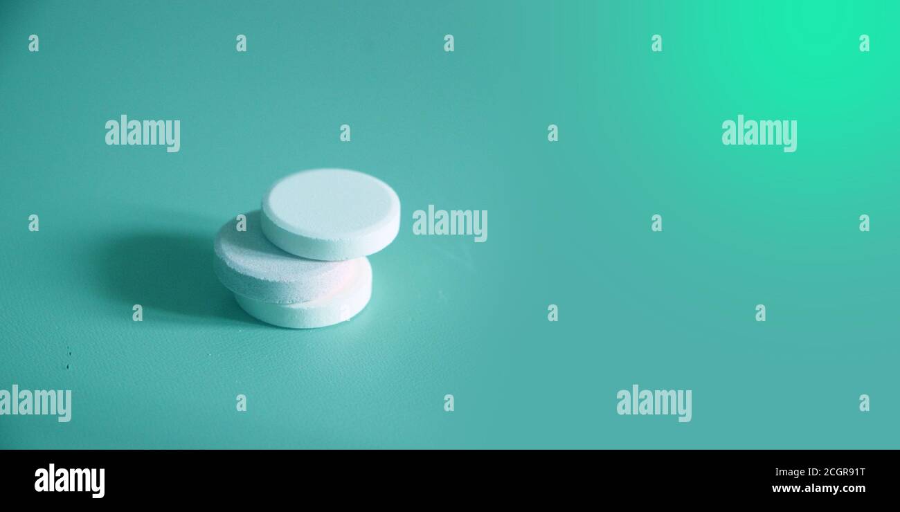 round pills on mint green table. medicine healthcare concept Stock ...