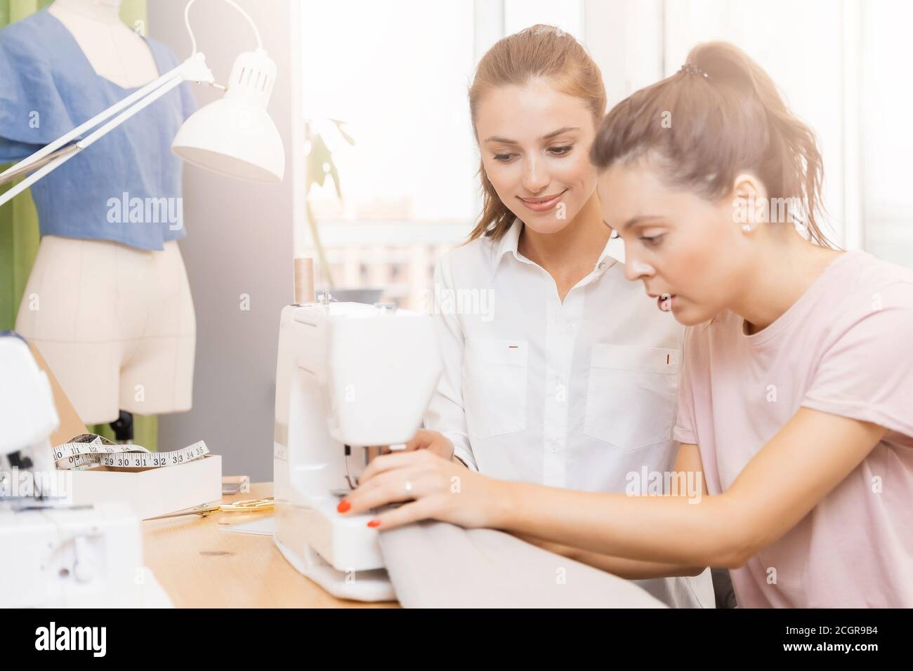 Young woman conducts individual lesson in master class in sewing ...