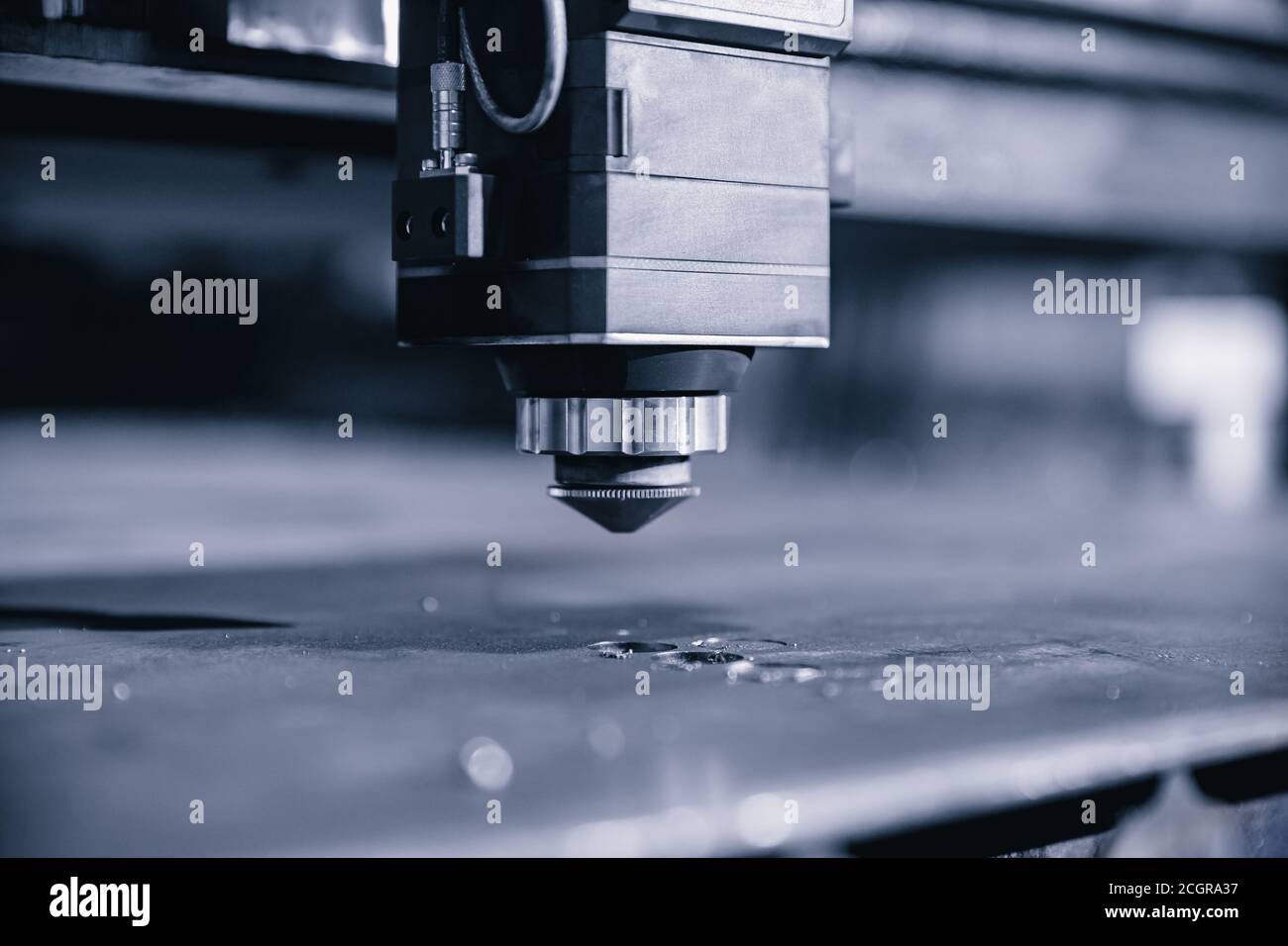 Blue color Laser CNC cut of metal with light spark, technology modern ...