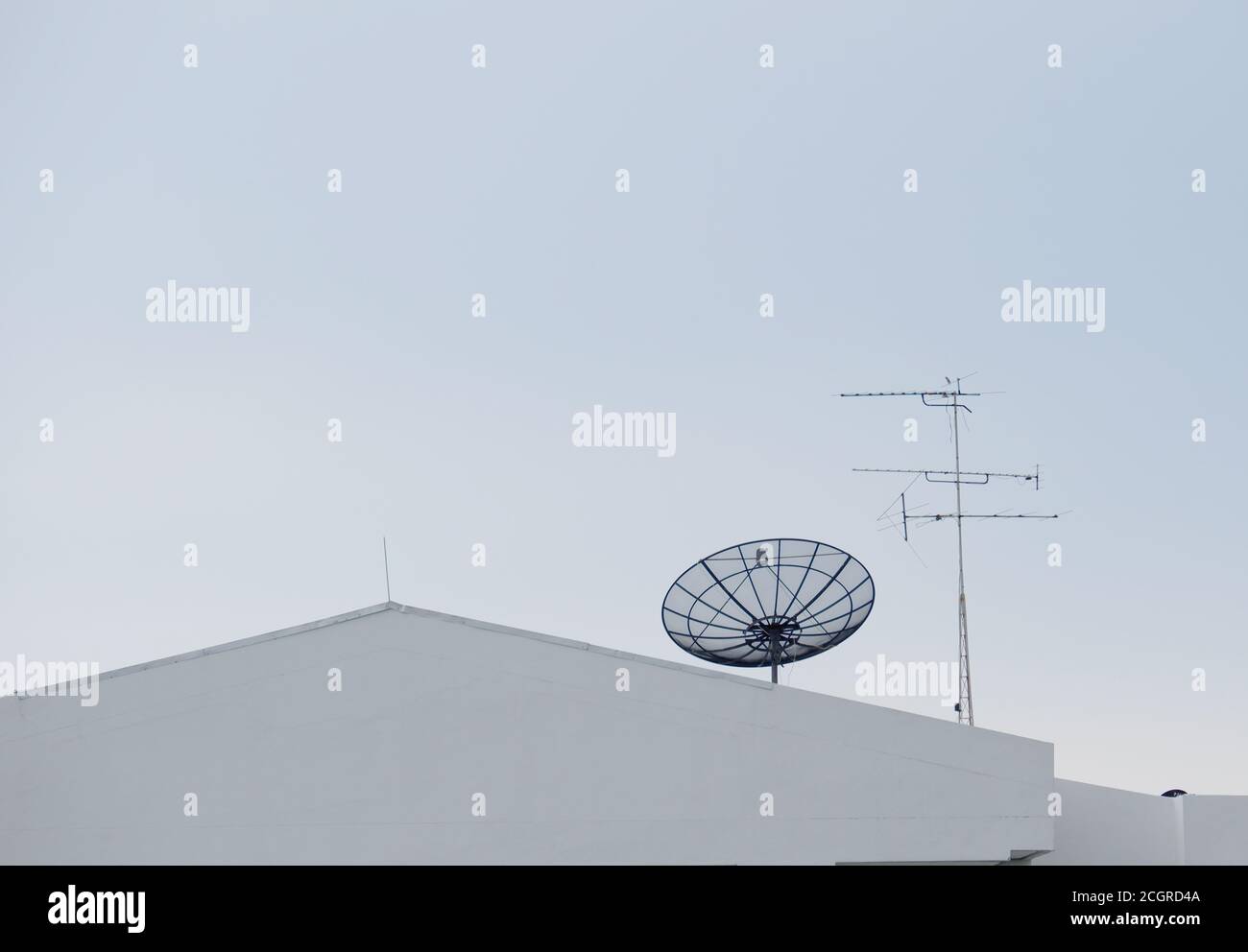 Satellite dish receivers above building roofs, communication technology ...