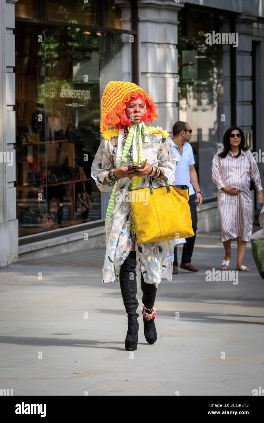Mayfair, London, UK, 22 Jun 2019. A model in colourful outfit walks ...