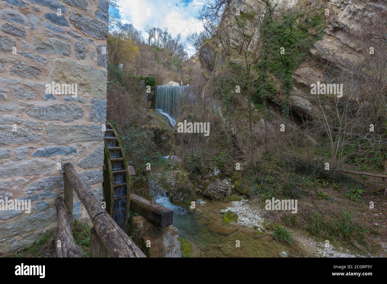 Waterfall in a valley with an ancient mill Stock Photo - Alamy