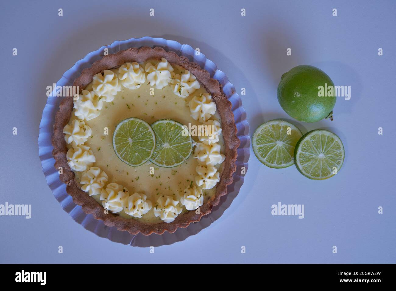 key lime pie. lime pie and whipped cream with sablé dough and garnished ...