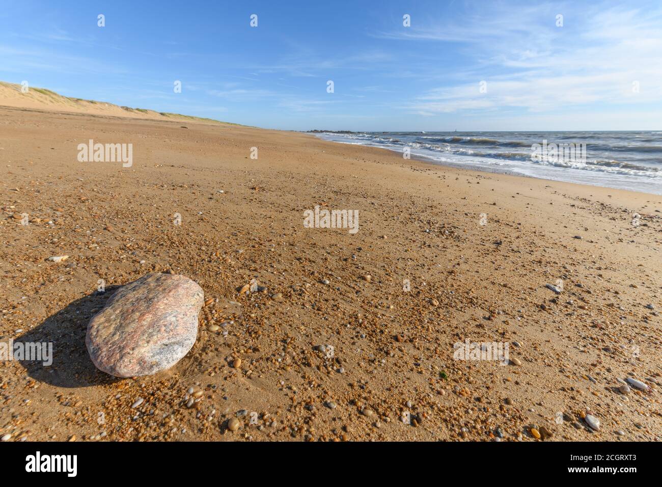 Stone washed up on the sand of a beach in France Stock Photo - Alamy