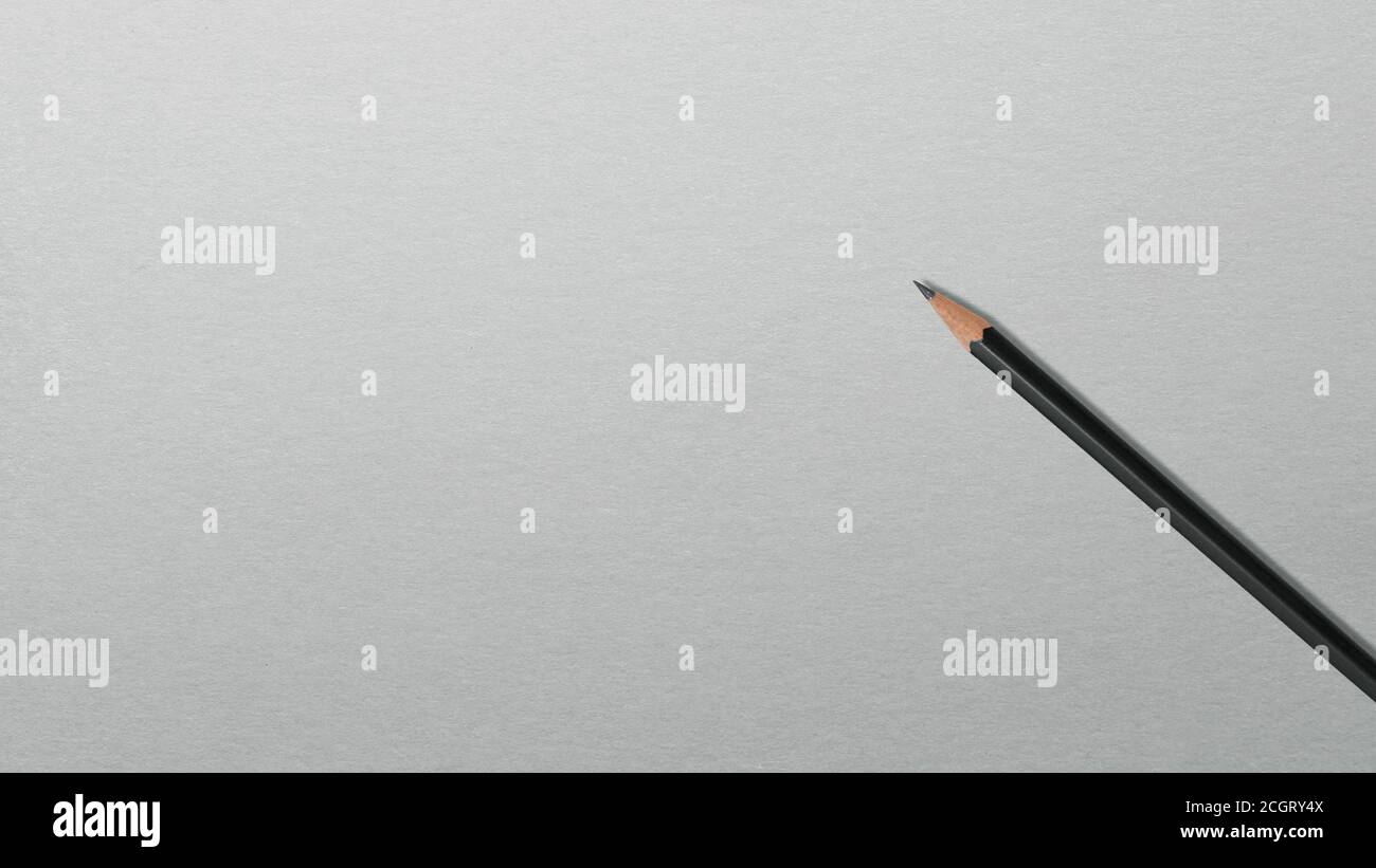 Black pencil on the table. Top view. Light background Stock Photo - Alamy