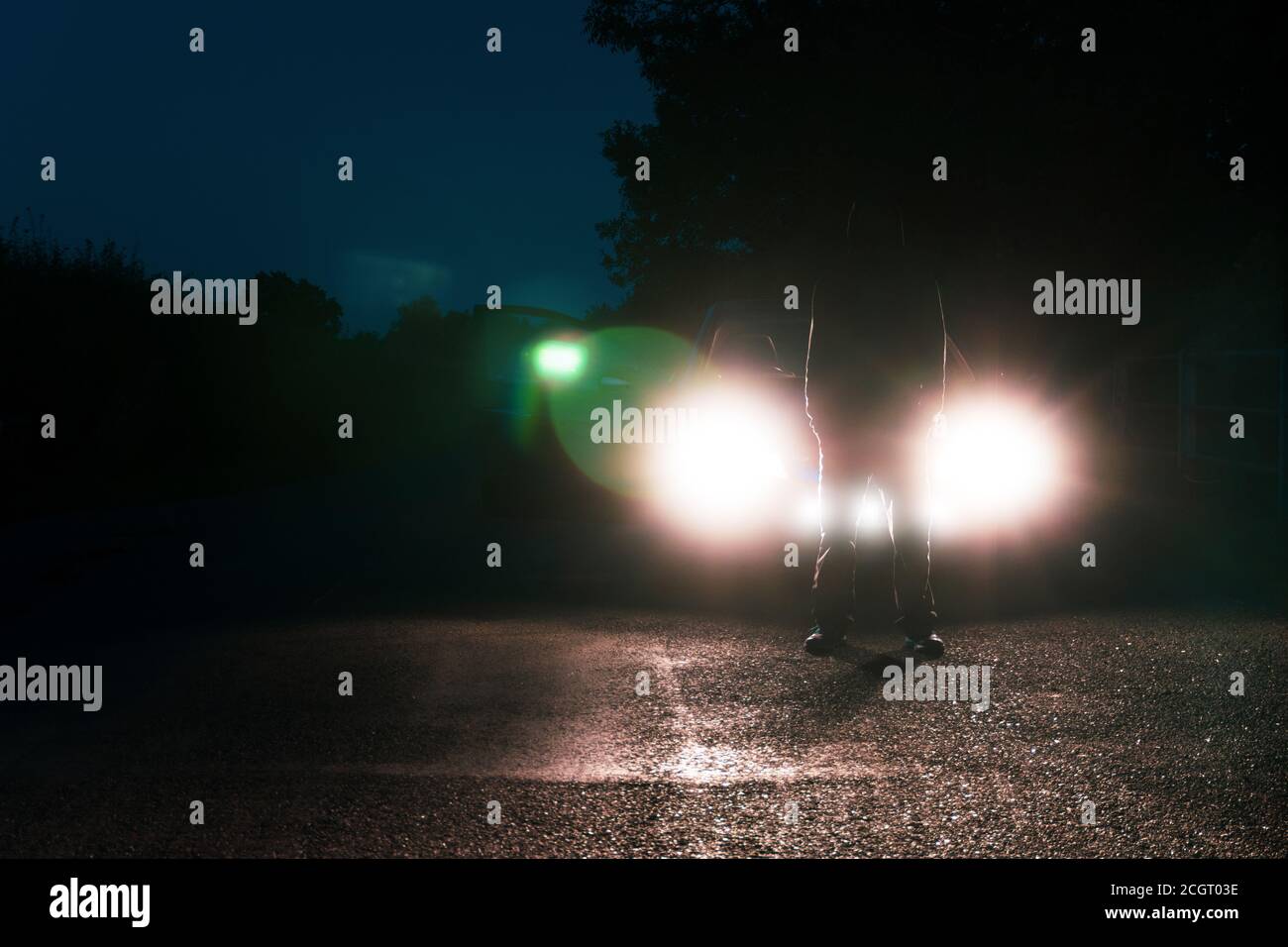 Man standing in front headlights hi-res stock photography and images ...