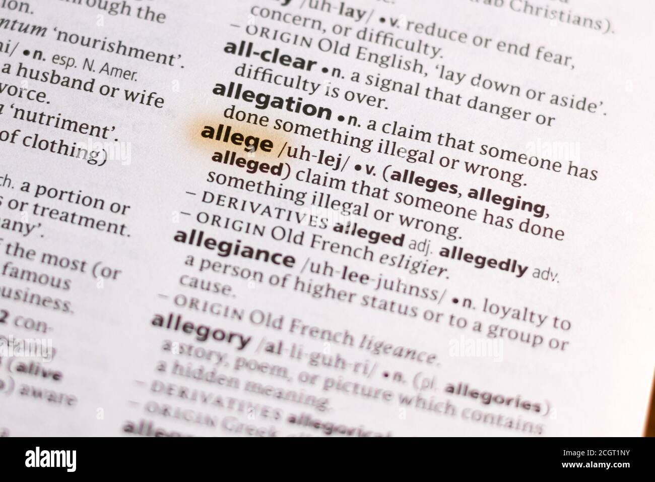 The word or phrase Allege in a dictionary highlighted with marker Stock ...