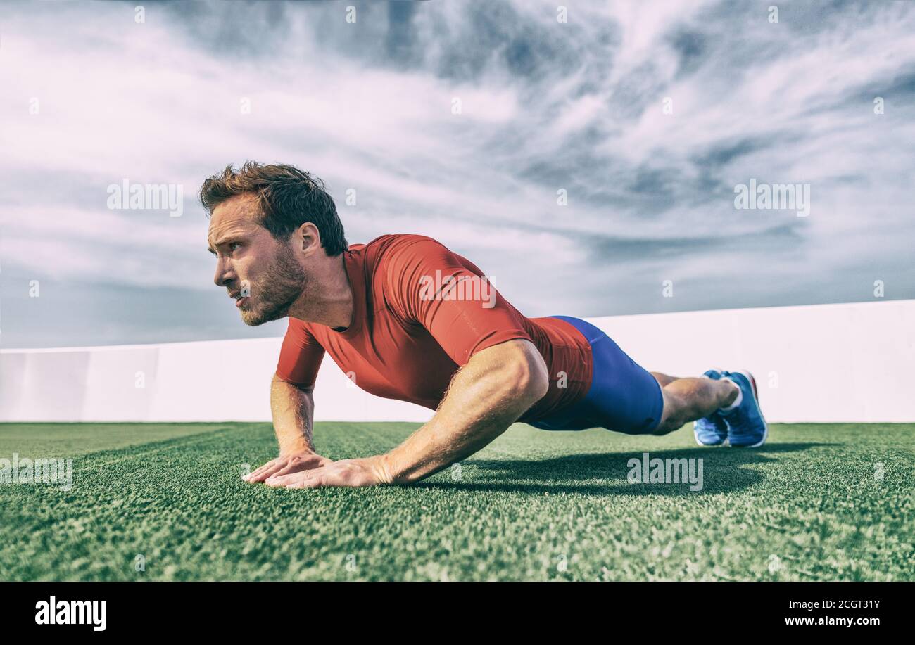 Fit man doing diamond hand push ups exercise at outdoor gym. Core body ...