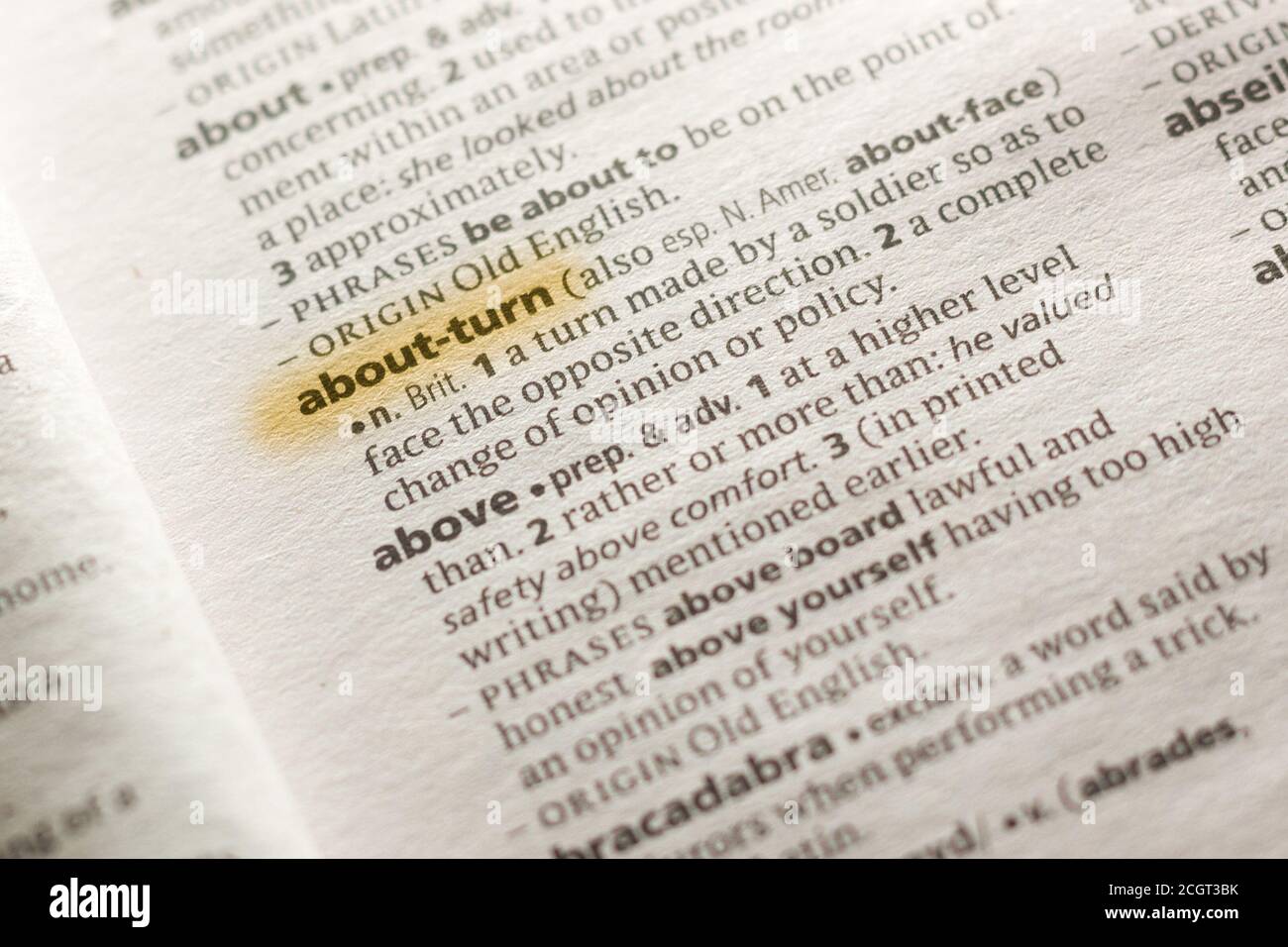 The word or phrase About-Turn in a dictionary highlighted with marker ...
