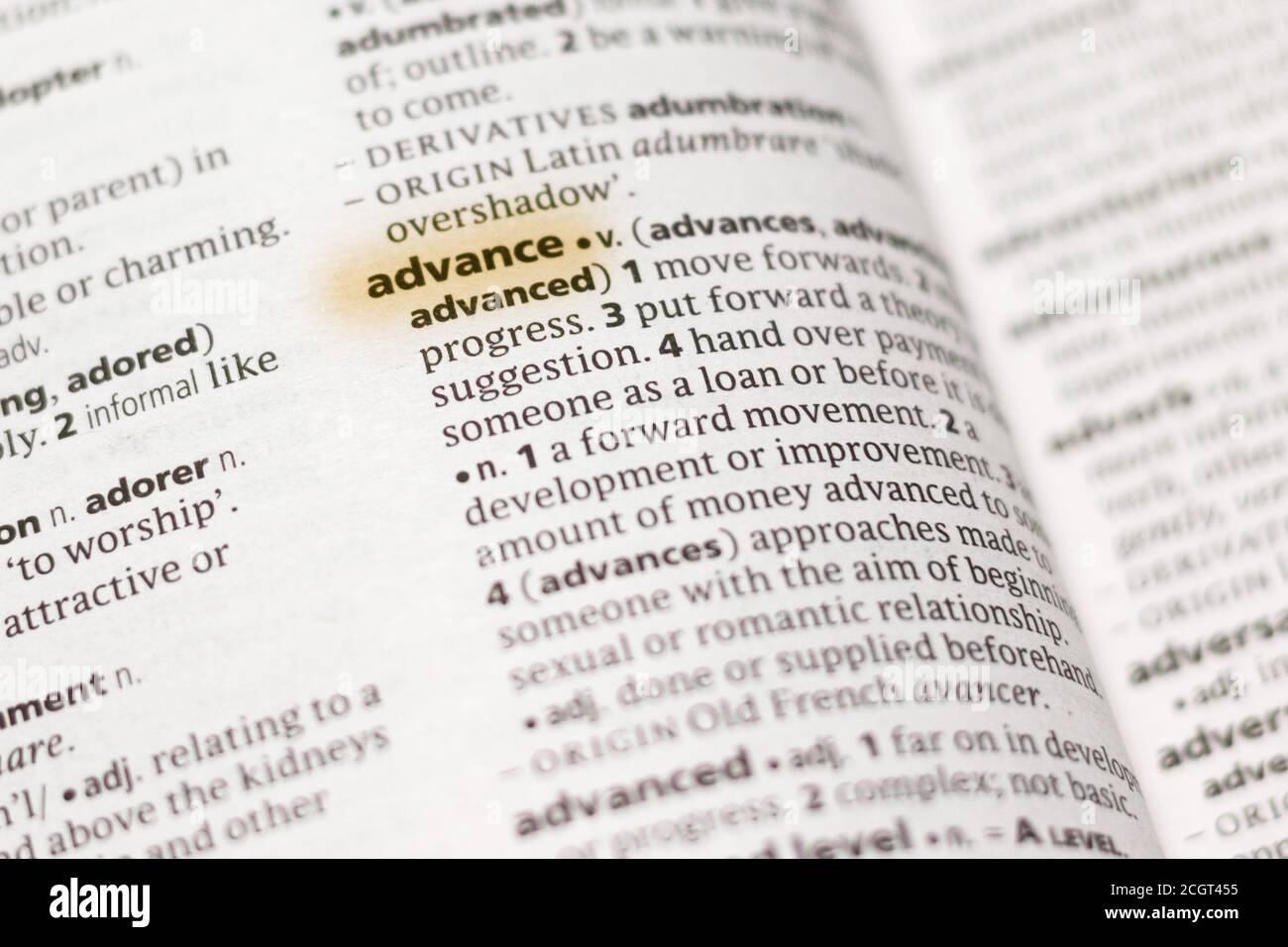 The word or phrase Advance in a dictionary highlighted with marker ...