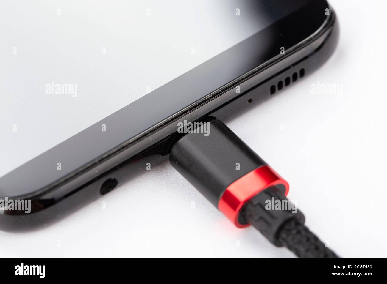 Smartphone Connects to Charger through USB Cable on a white background ...