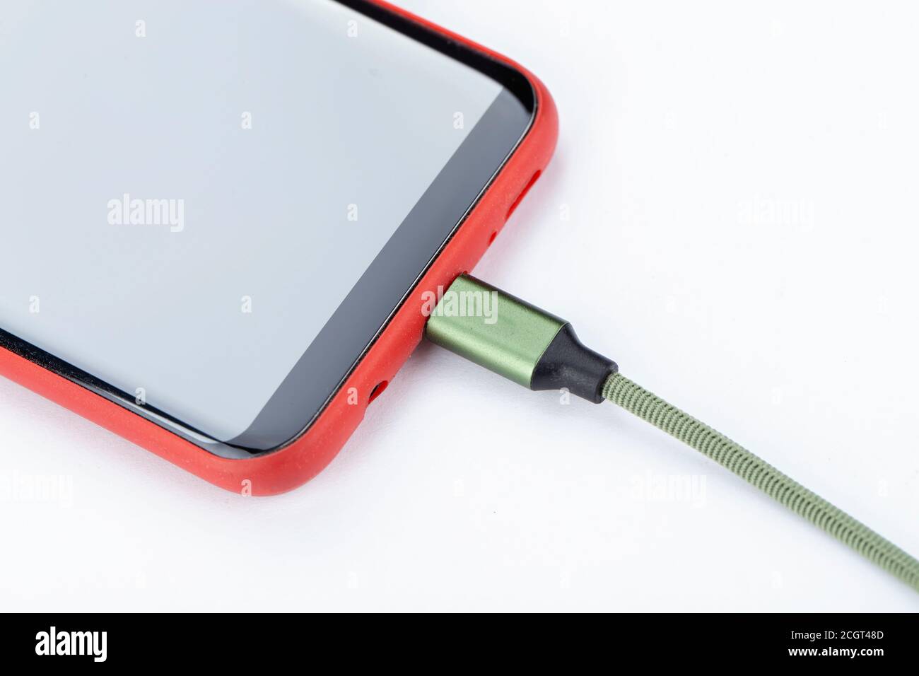 Smartphone Connects to Charger through USB Cable on a white background ...