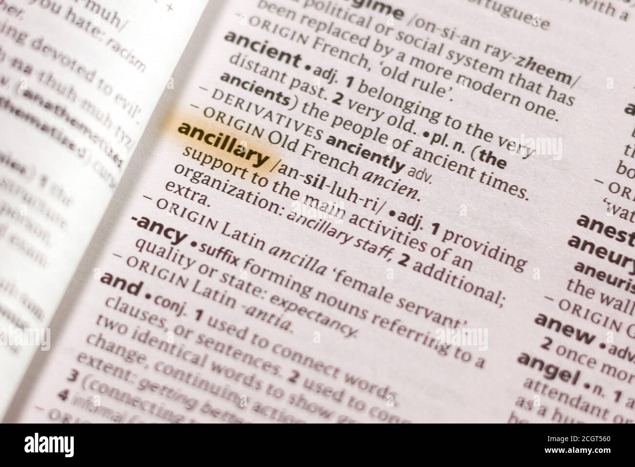 The word or phrase Ancillary in a dictionary highlighted with marker ...