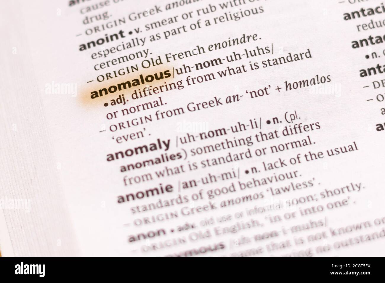 The word or phrase Anomalous in a dictionary highlighted with marker ...