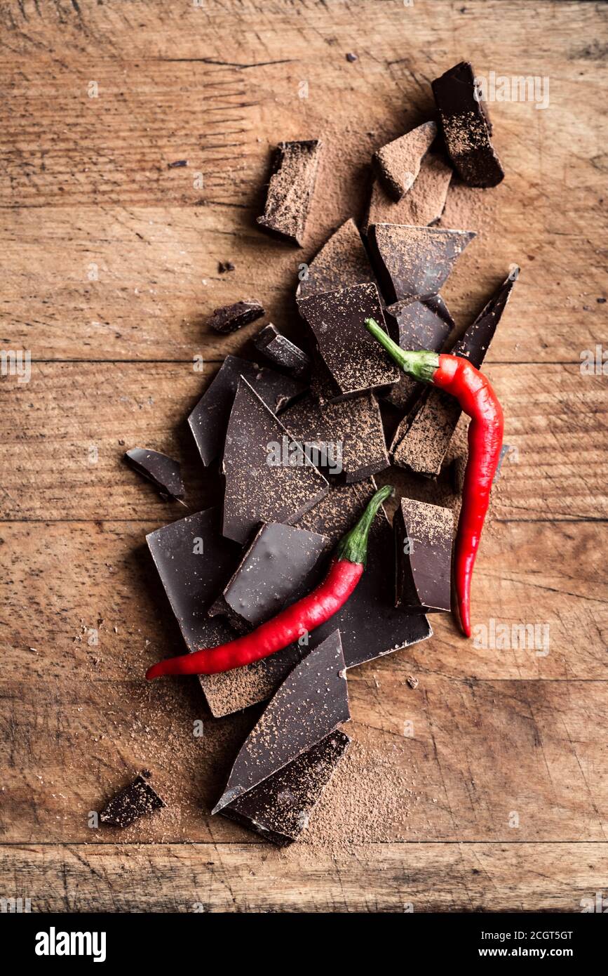 Dark Chocolate Background. Crashed chocolate pieces with chilli peppers ...