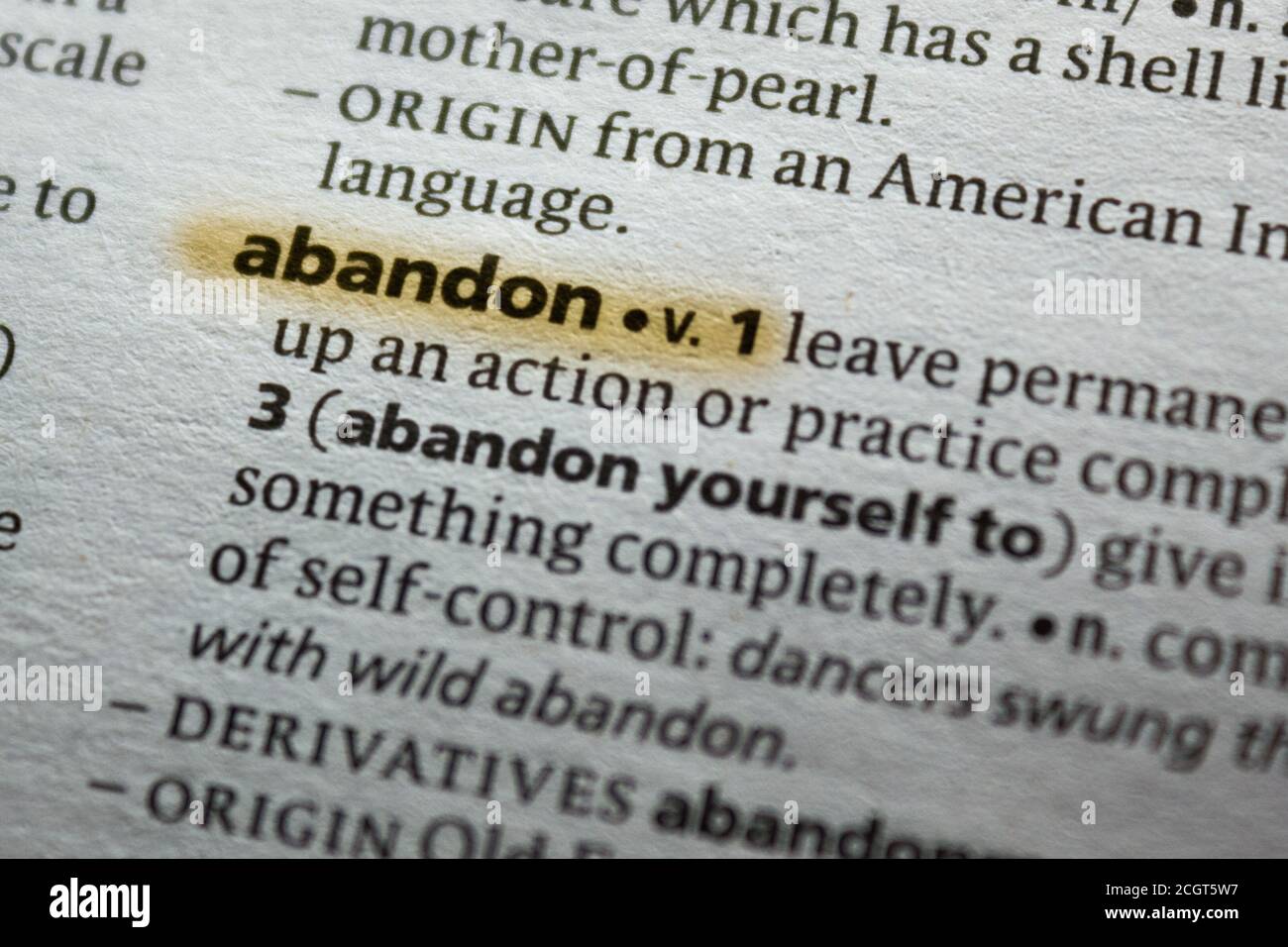 The word or phrase Abandon in a dictionary highlighted with marker ...
