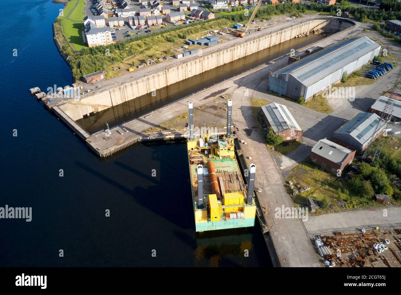 Shipbuilding construction ship in dry dock aerial view at shipyard ...