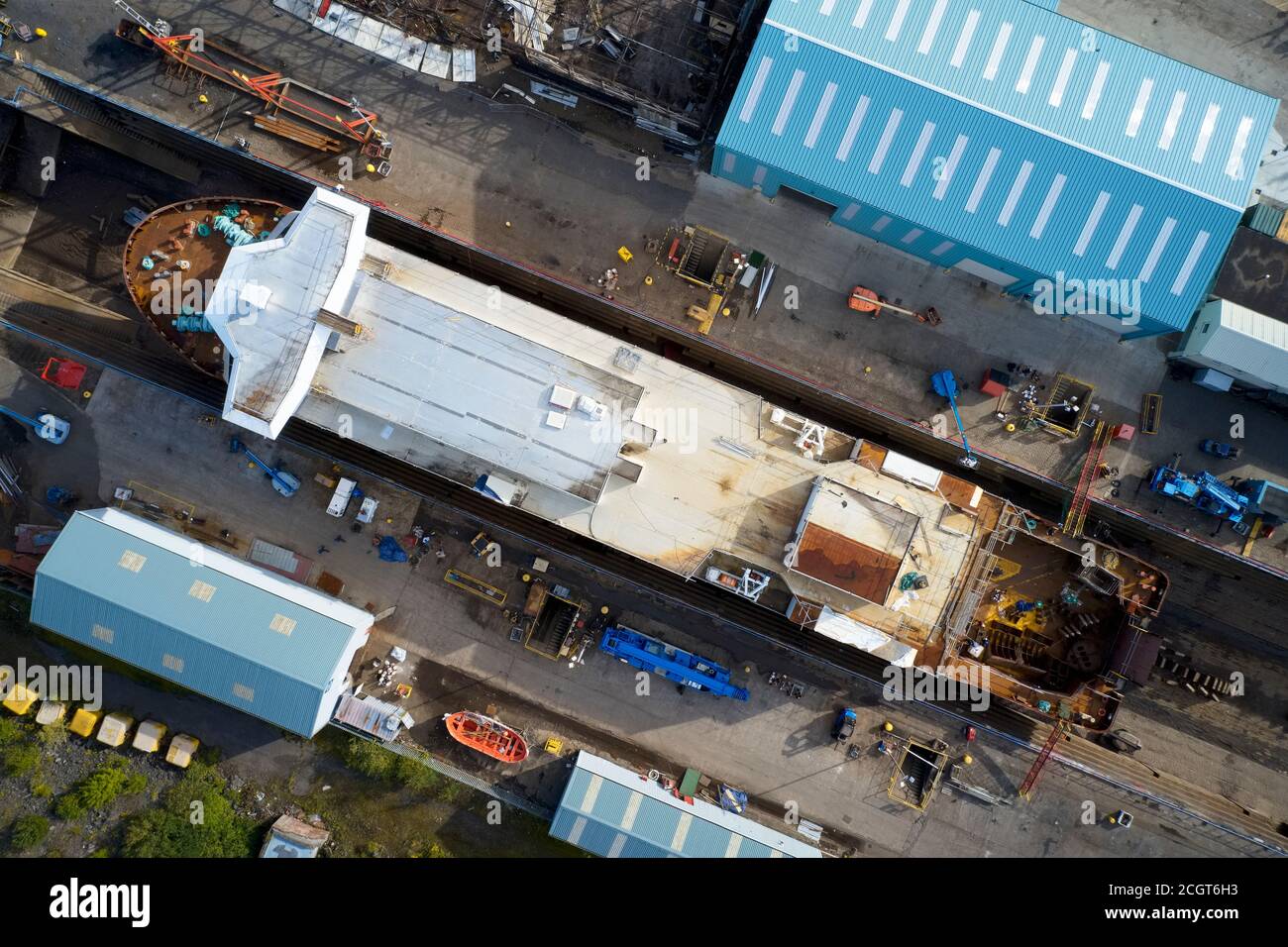 Shipbuilding construction ship in dry dock aerial view at shipyard ...