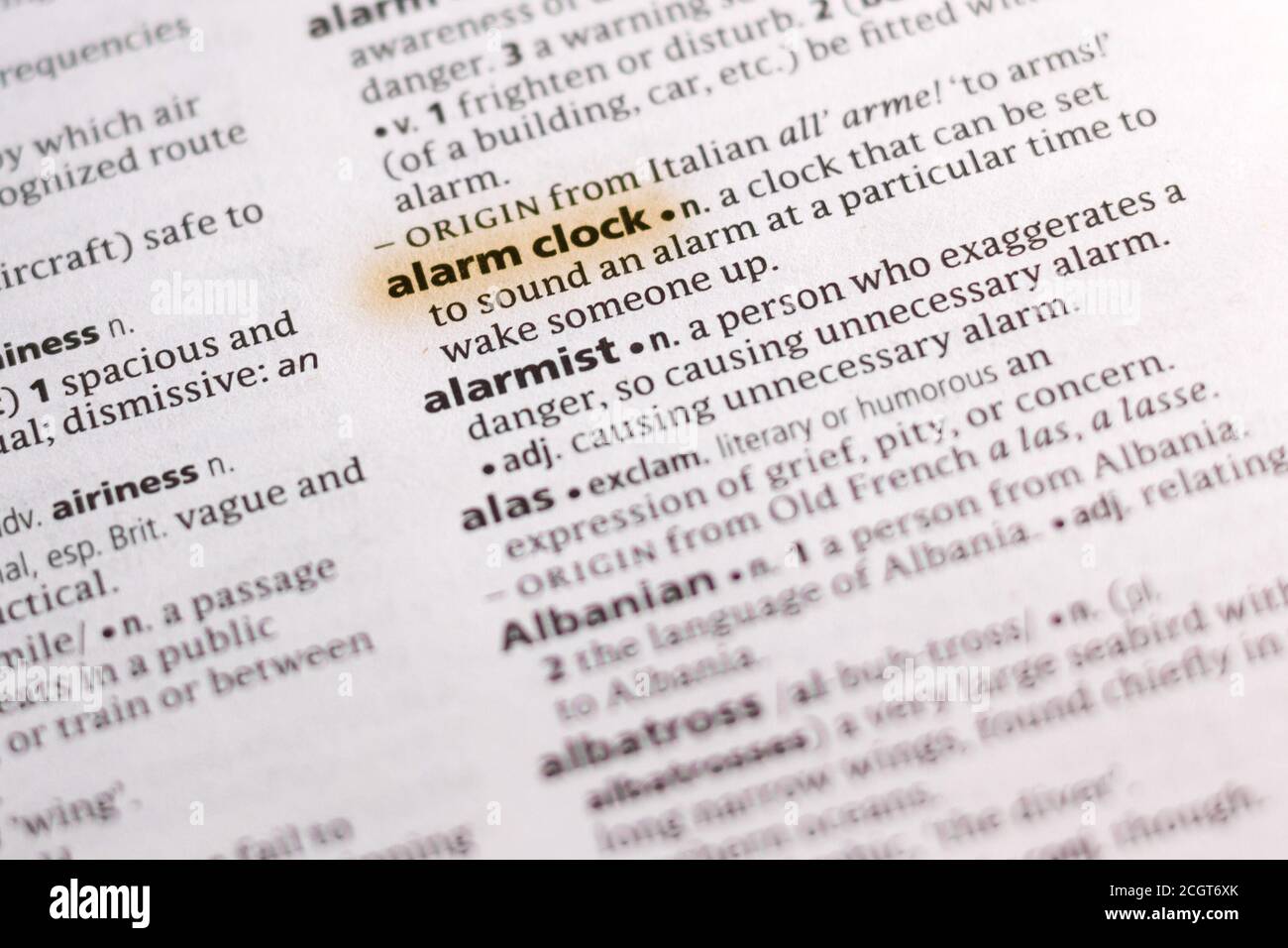 The word or phrase Alarm Clock in a dictionary highlighted with marker ...