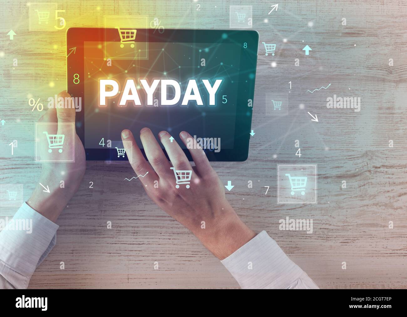 Close-up of a hand holding tablet with PAYDAY inscription, online ...