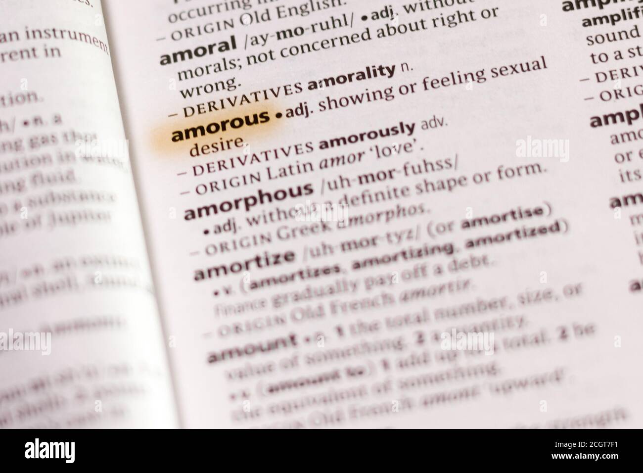 The word or phrase Amorous in a dictionary highlighted with marker ...