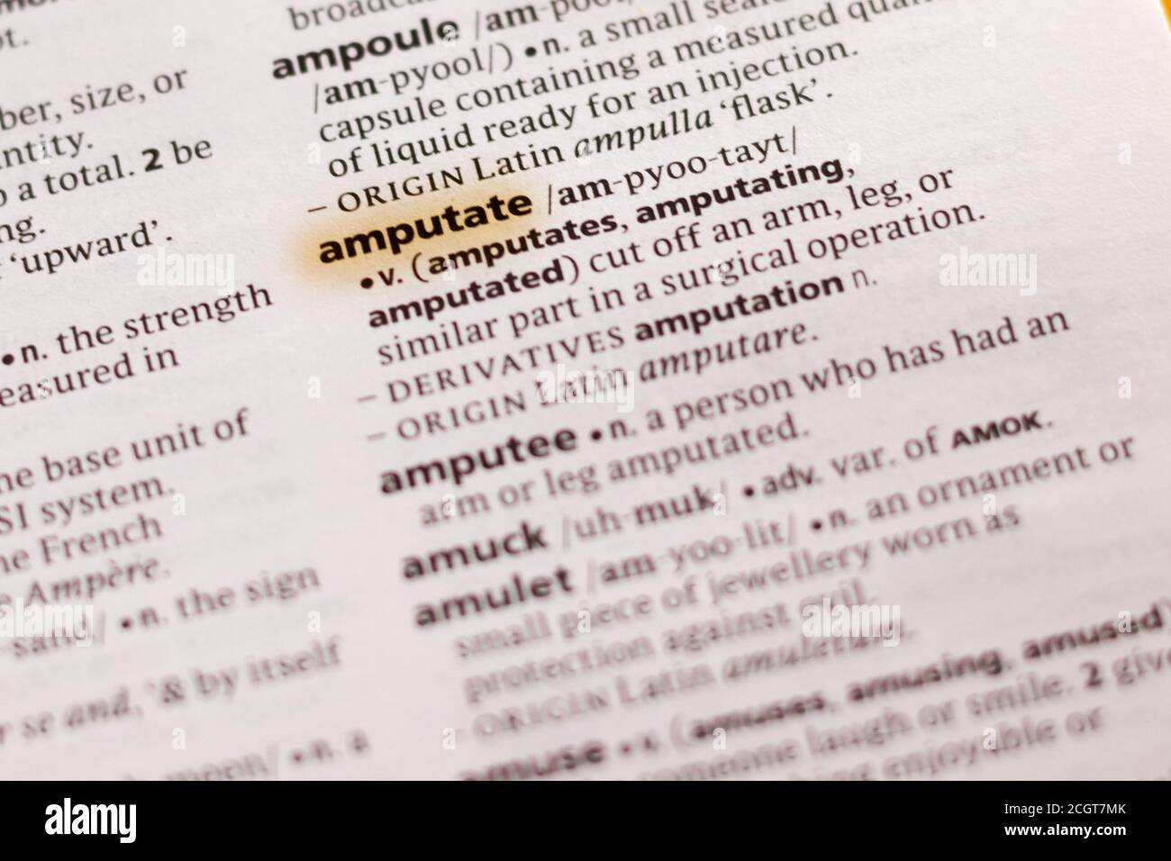 The word or phrase Amputate in a dictionary highlighted with marker ...