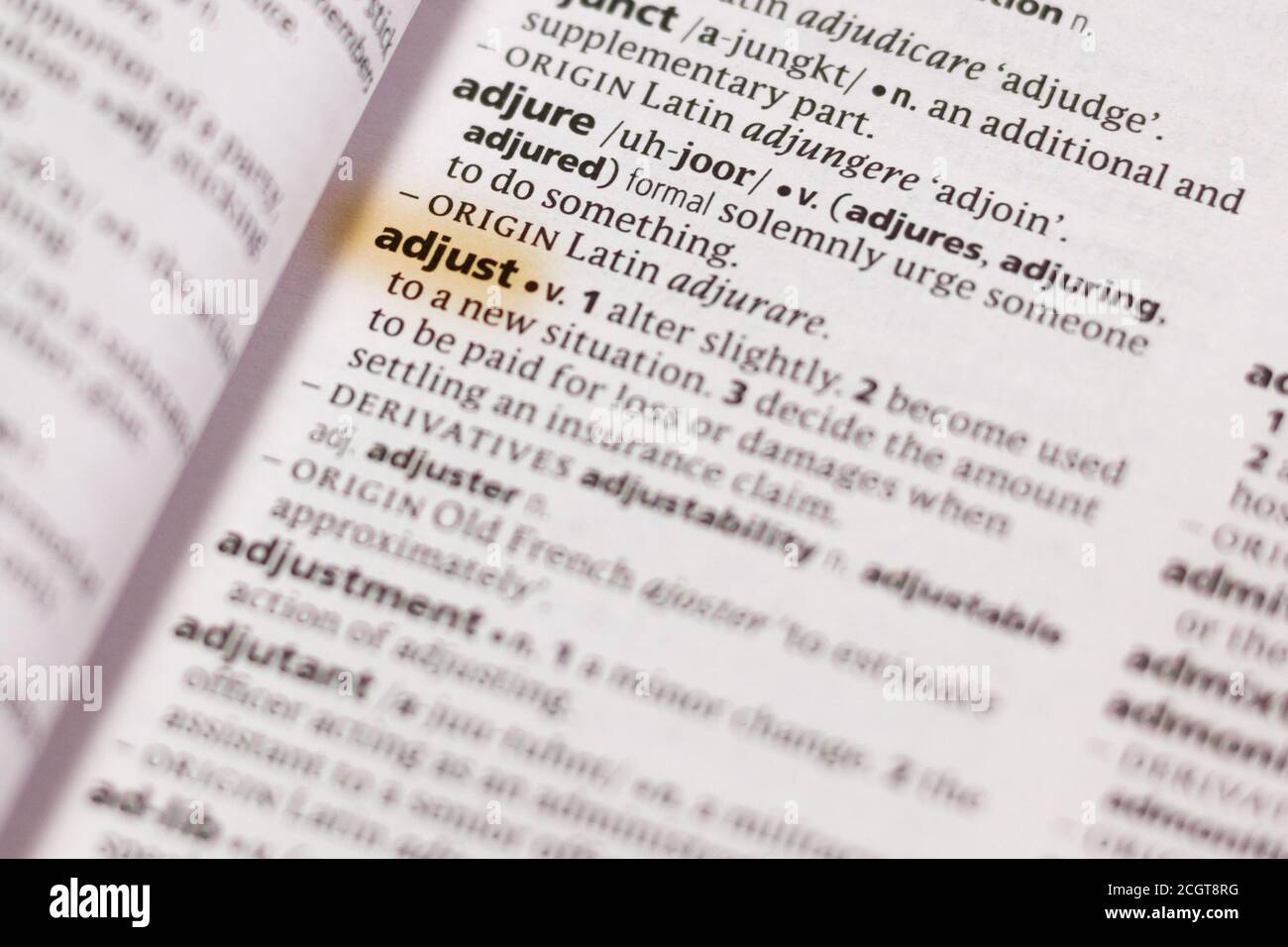 The word or phrase Adjust in a dictionary highlighted with marker Stock ...