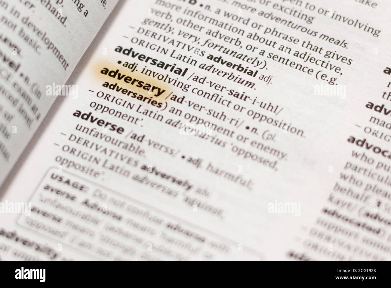 The word or phrase Adversary in a dictionary highlighted with marker ...