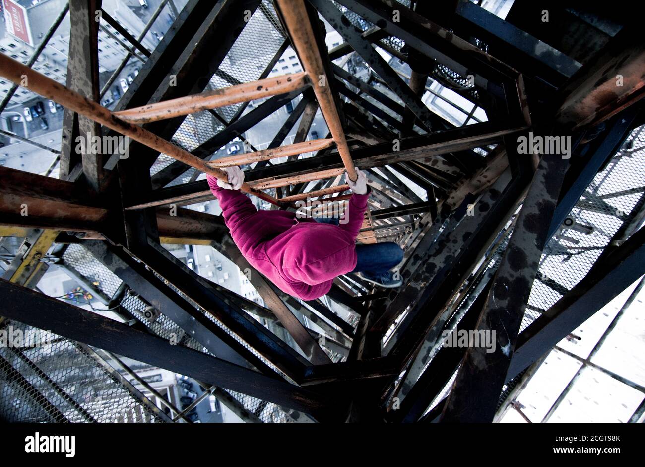 Man climbing crane Stock Photo - Alamy