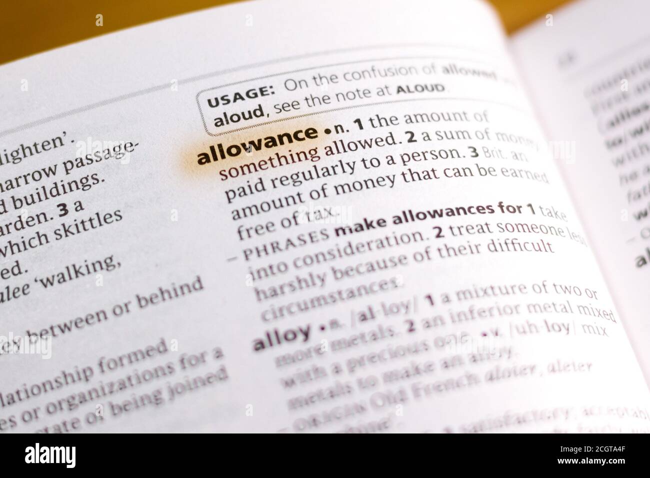 The word or phrase Allowance in a dictionary highlighted with marker ...
