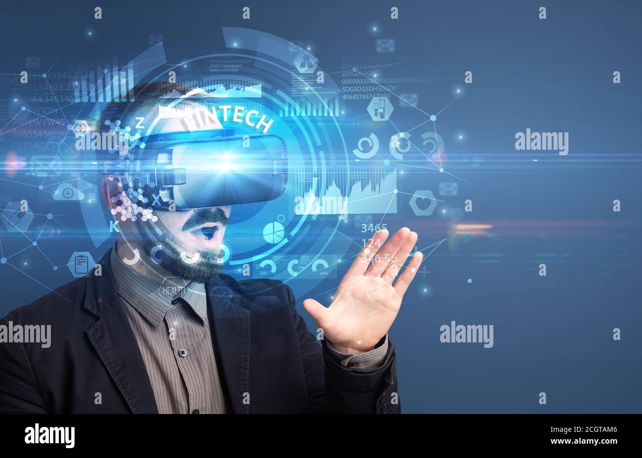 Businessman looking through Virtual Reality glasses with FINTECH ...