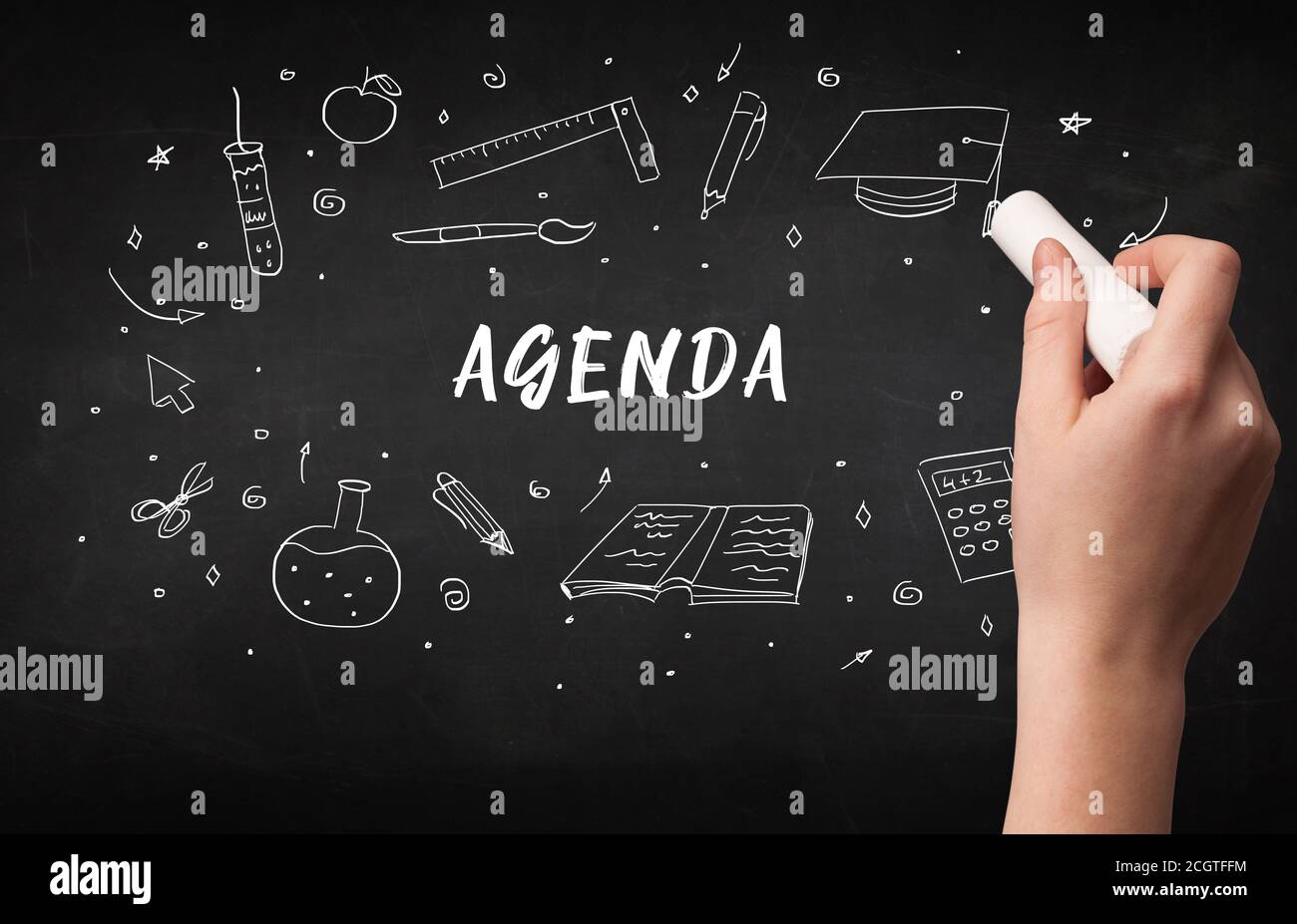 Hand drawing AGENDA inscription with white chalk on blackboard ...
