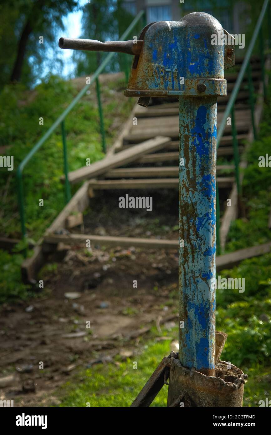 Old metal water pump on russian slum village Stock Photo - Alamy