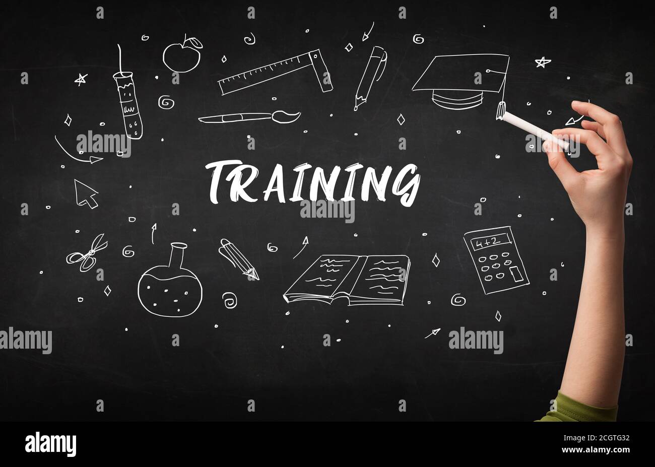 Hand drawing TRAINING inscription with white chalk on blackboard ...