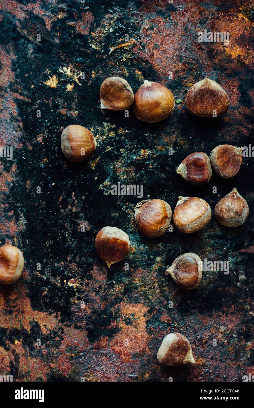 Flat view of chestnuts on black metal surface Stock Photo - Alamy