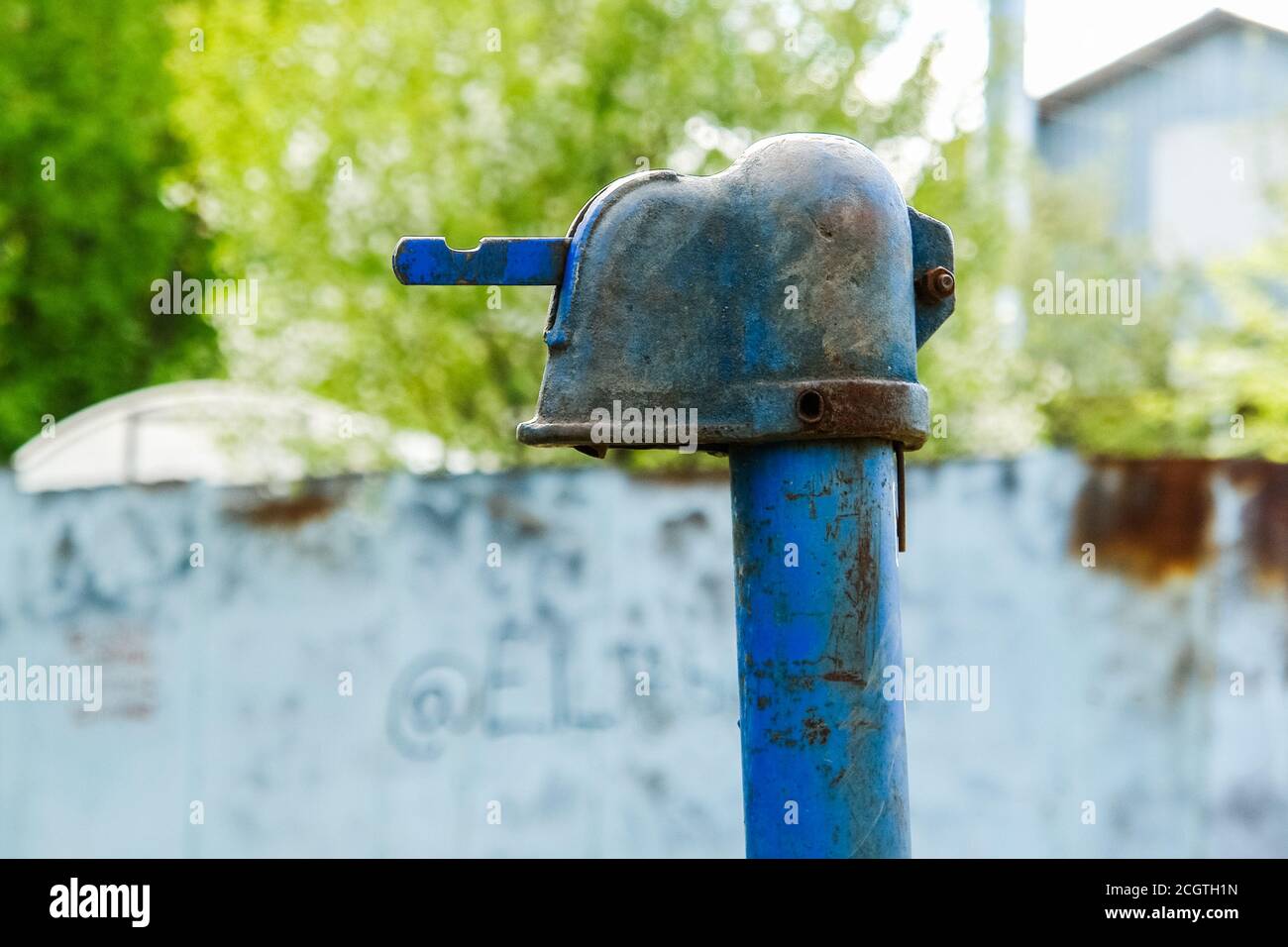 Old metal water pump on russian slum village Stock Photo - Alamy