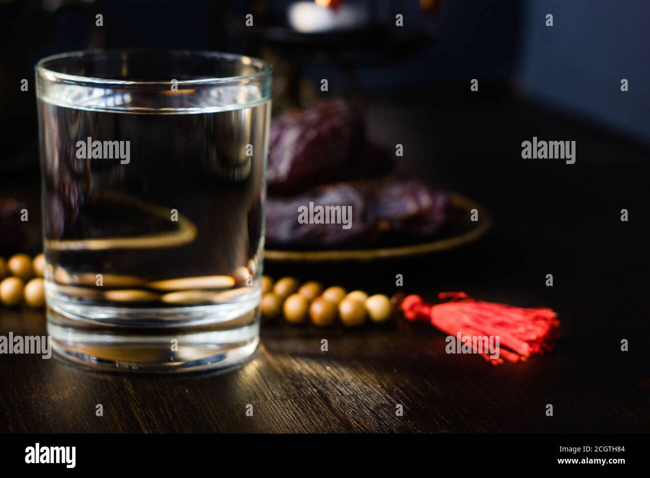 Iftar water for Ramadan fast opening on black table Stock Photo - Alamy