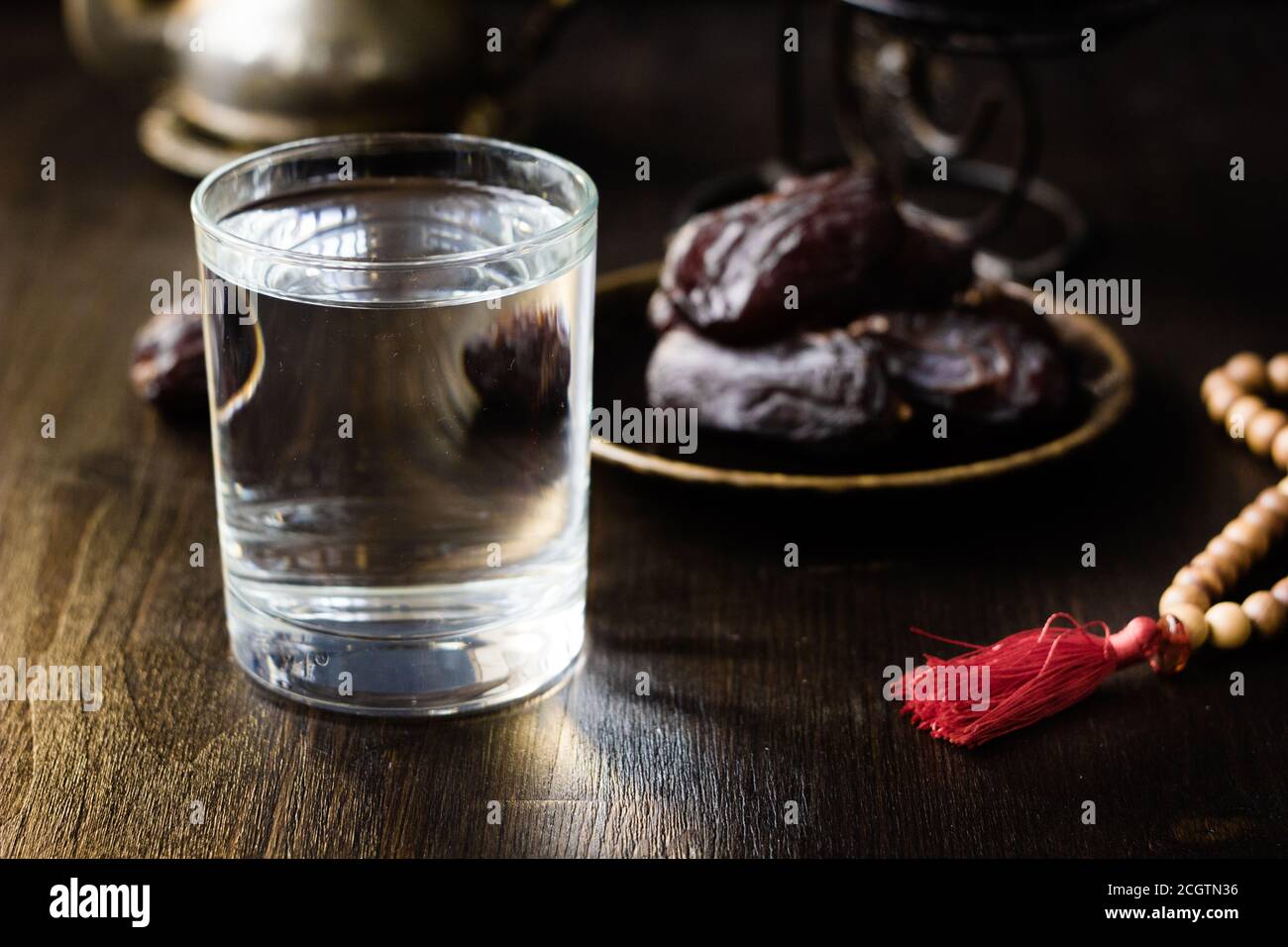 Iftar water for Ramadan fast opening on black table Stock Photo - Alamy