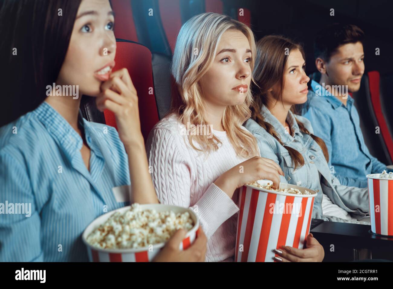 Young people friends together in the cinema Stock Photo - Alamy