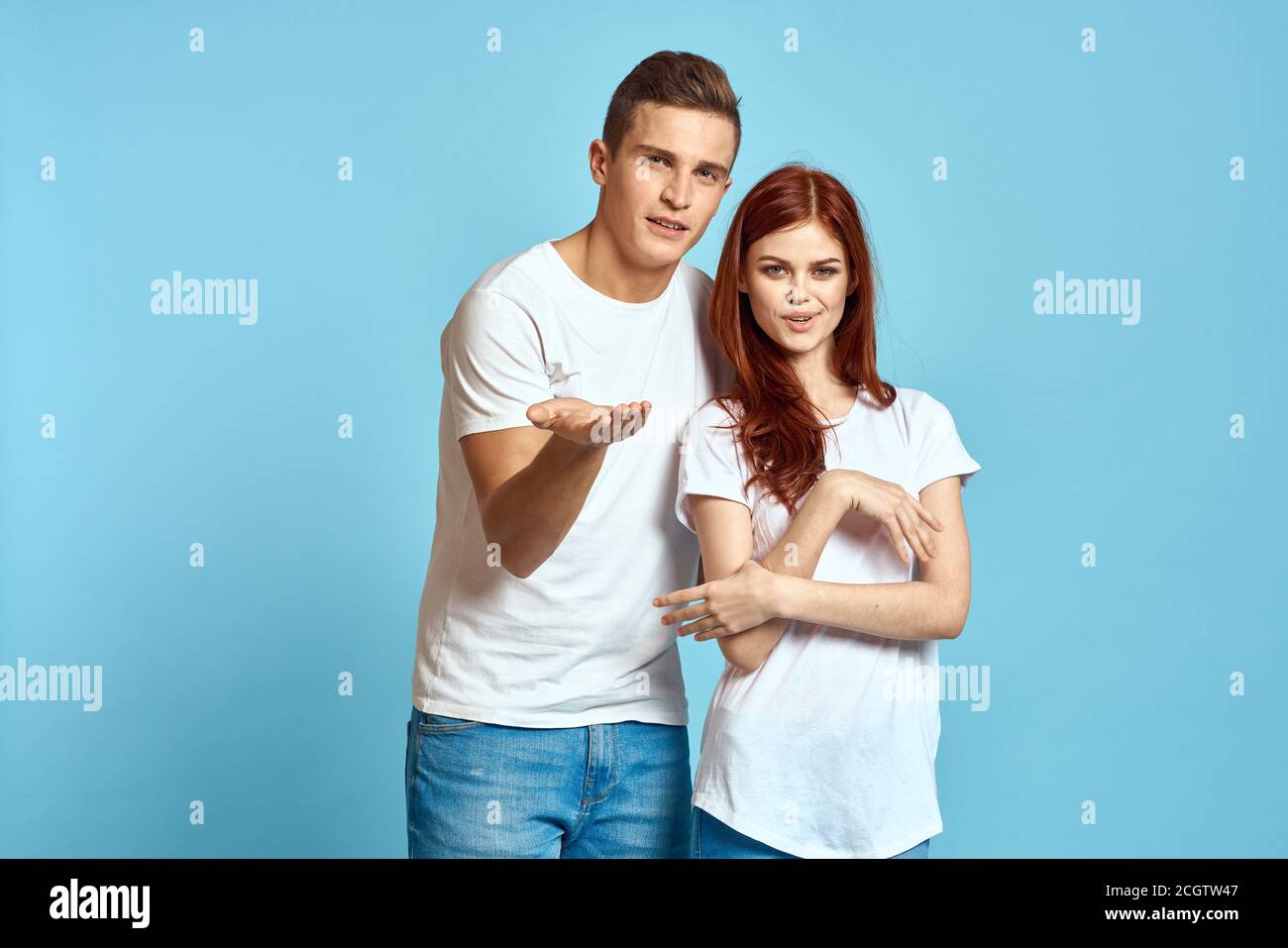 Young woman and man stinks relationship on blue background cropped view ...