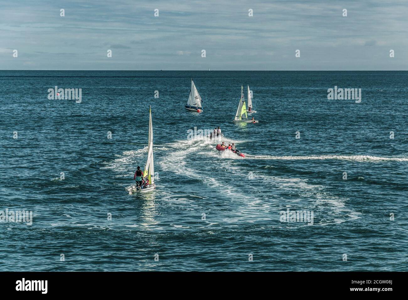 Rescue powerboats (rib) speeding to distant sailing dinghies Stock ...