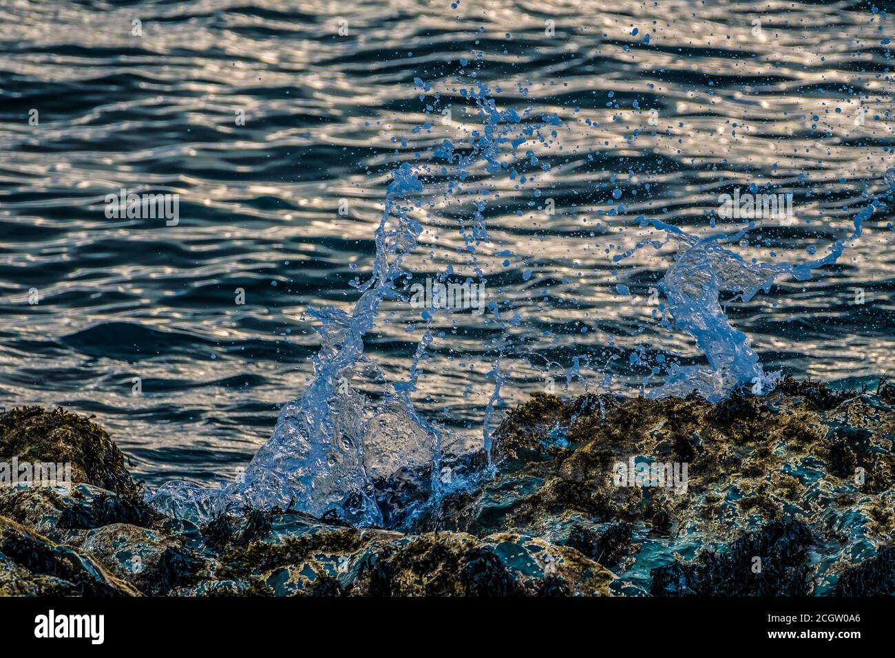 Sea wave splash over the rock Stock Photo - Alamy