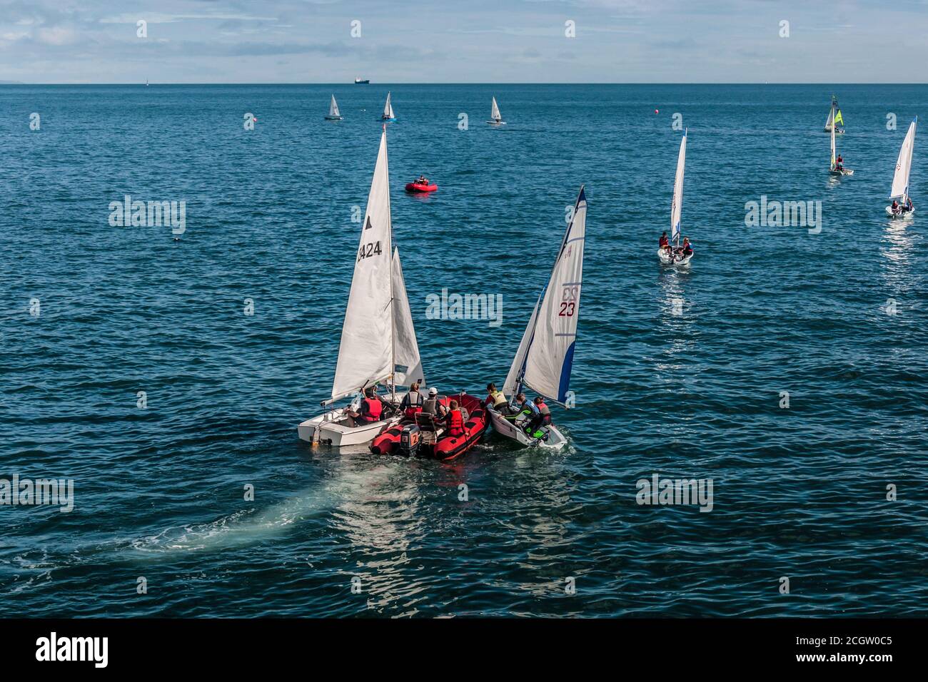 Powerboat (rib) helps sailing dinghies to move in no wind condition ...