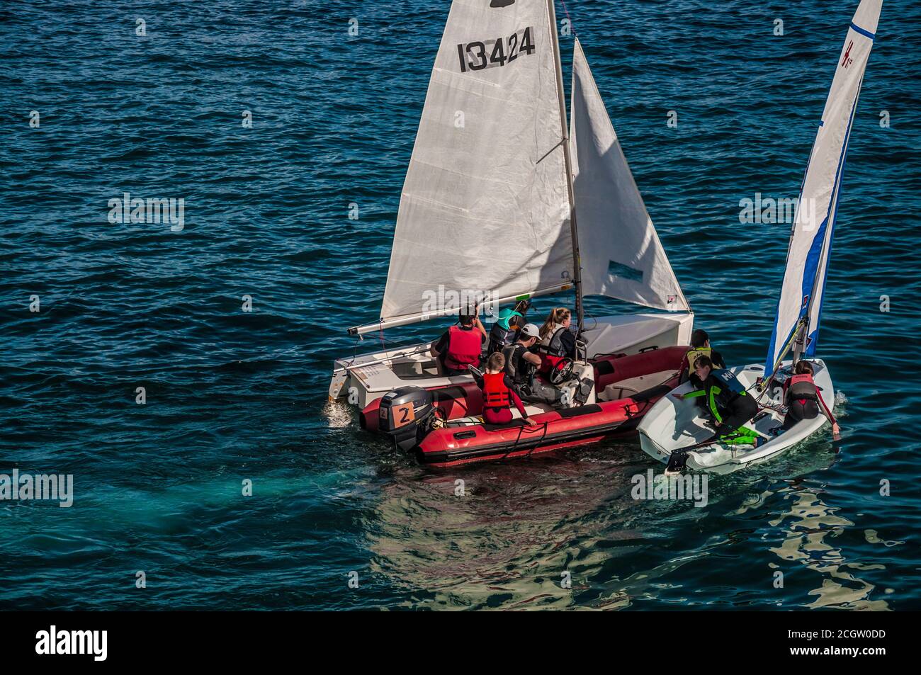 Powerboat (rib) helps sailing dinghies to move in no wind condition ...