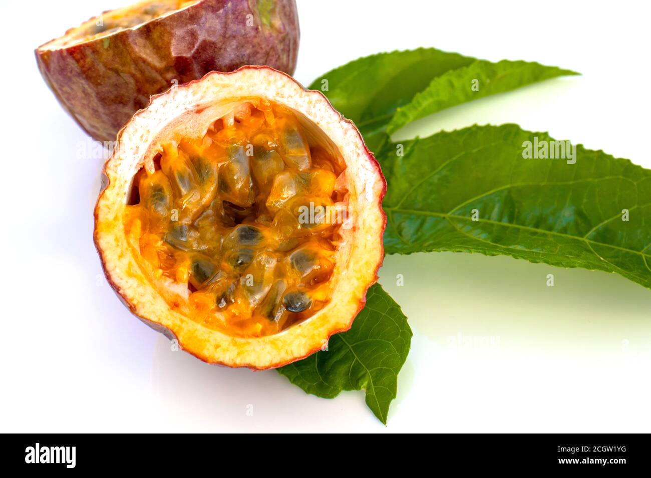 Maracuja cut in half and whole with leaf on white background. Passion ...